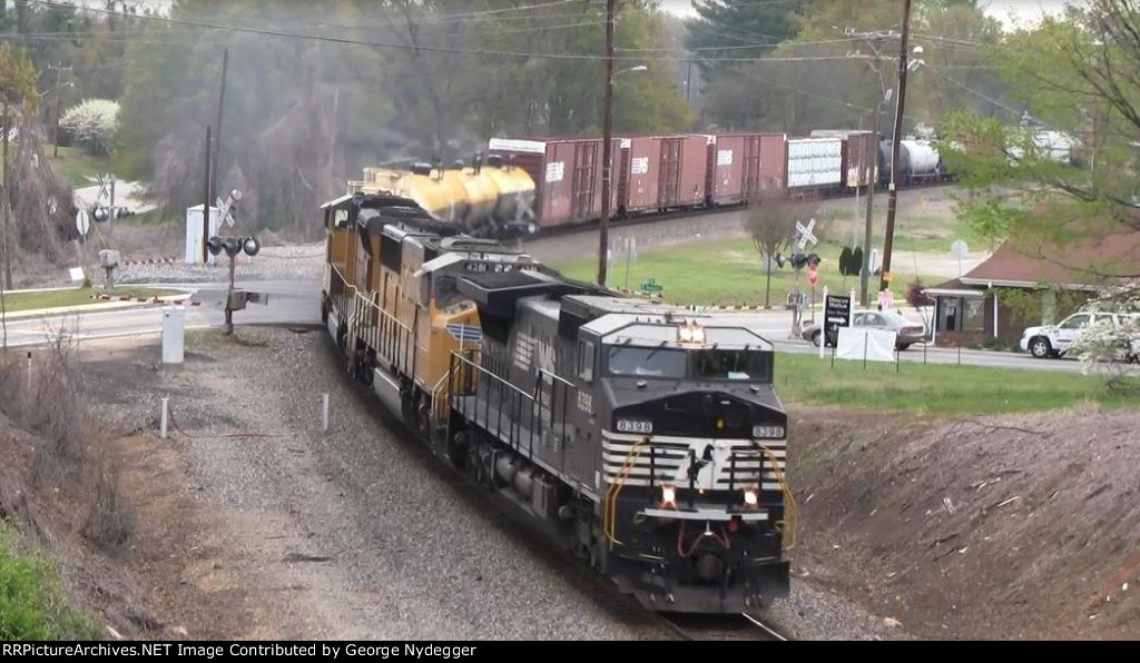 NS 8398 (C40-8W), UP 4281 & 4887 (SD70M) pulling a mixed freight train